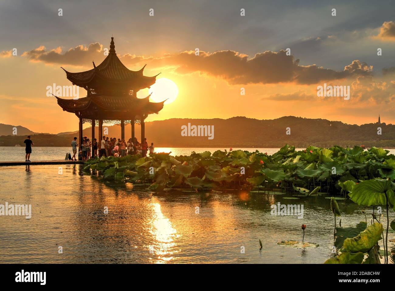 Beautiful sunset under light rain on West Lake in Hangzhou, China with ...