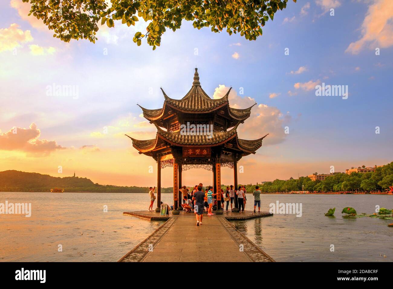 Beautiful sunset under light rain on West Lake in Hangzhou, China with ...
