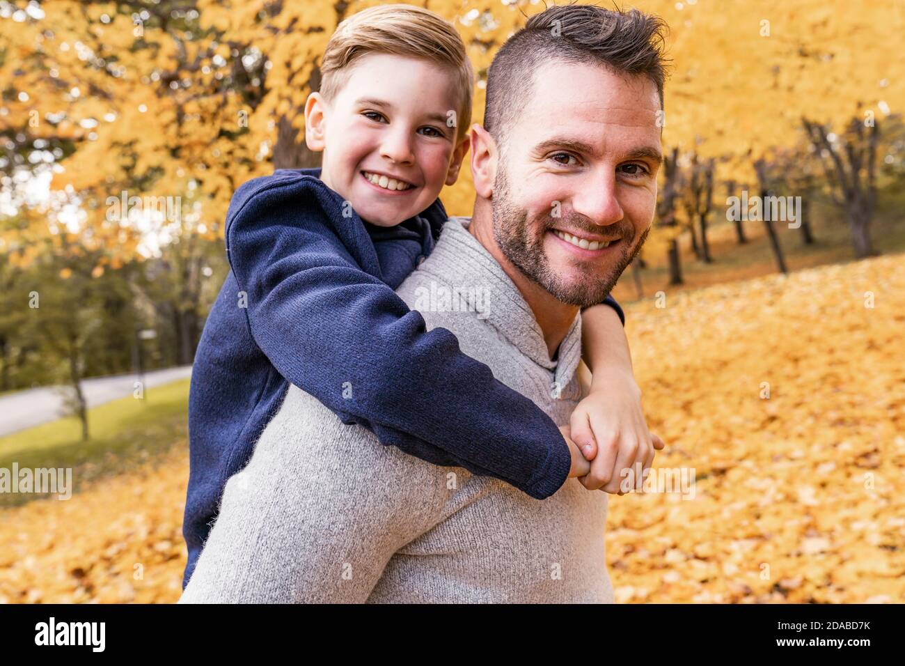 Happy family father and child boy in the autumn leaf fall in park ...