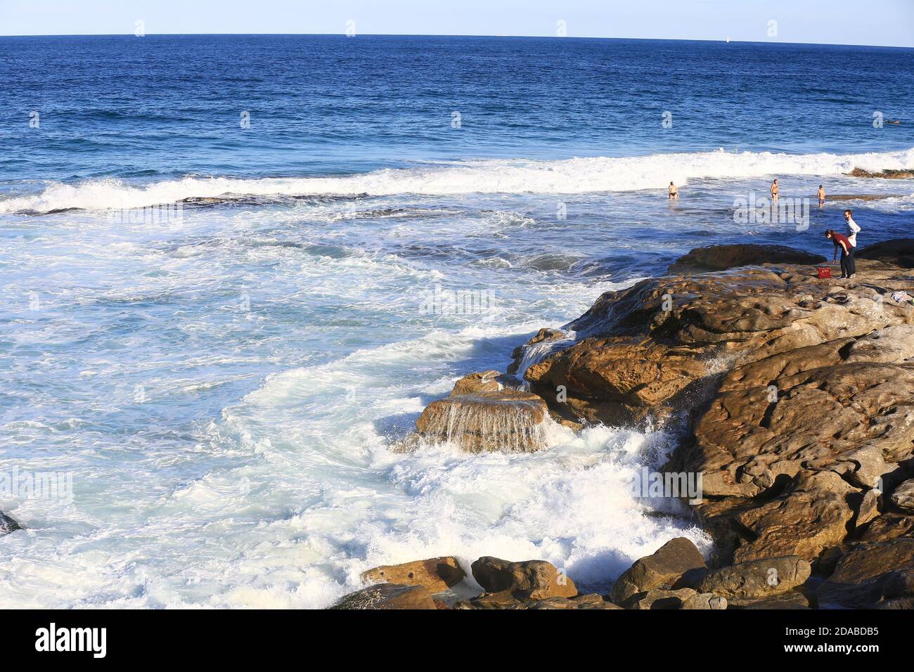 Bondi beach with wave and rocks Stock Photo - Alamy