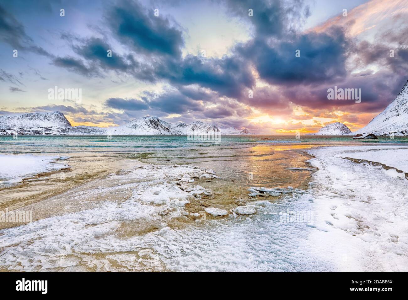 Fabulous winter scenery with Haukland beach during sunset and snowy ...