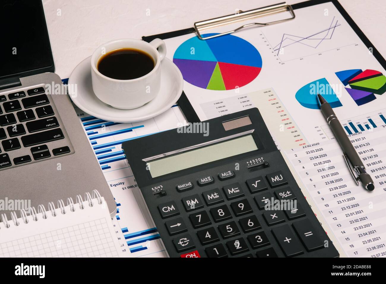 Accountant work desk with computer, calculator, cup of coffee and ...