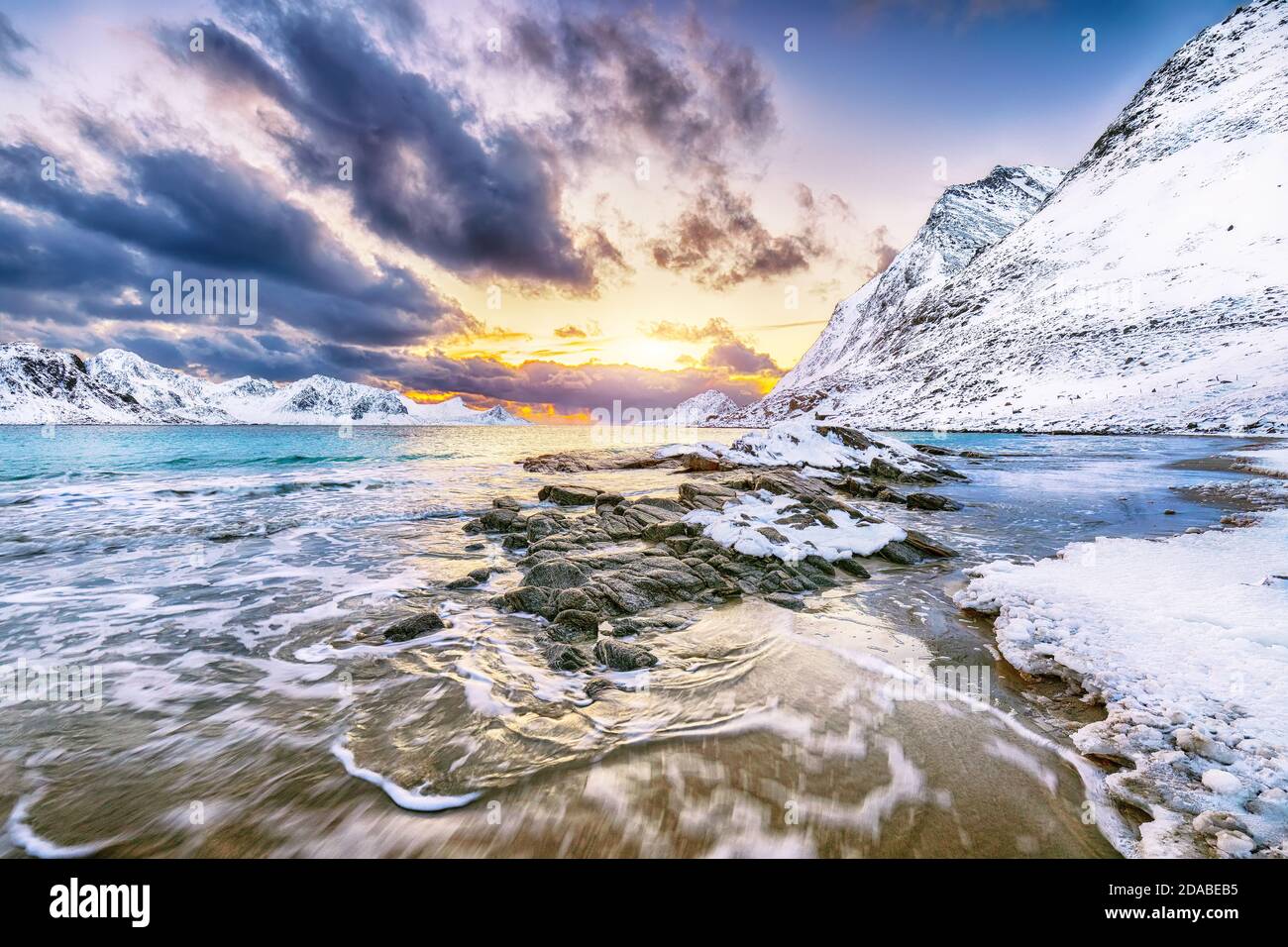 Fabulous winter scenery with Haukland beach during sunset and snowy ...