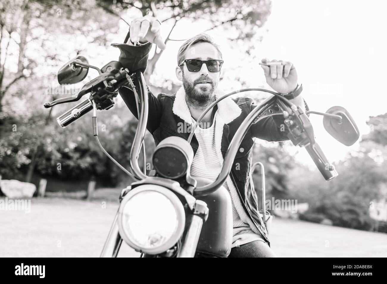 Unsaturated photo of a man with rude expression wearing sunglasses and ...