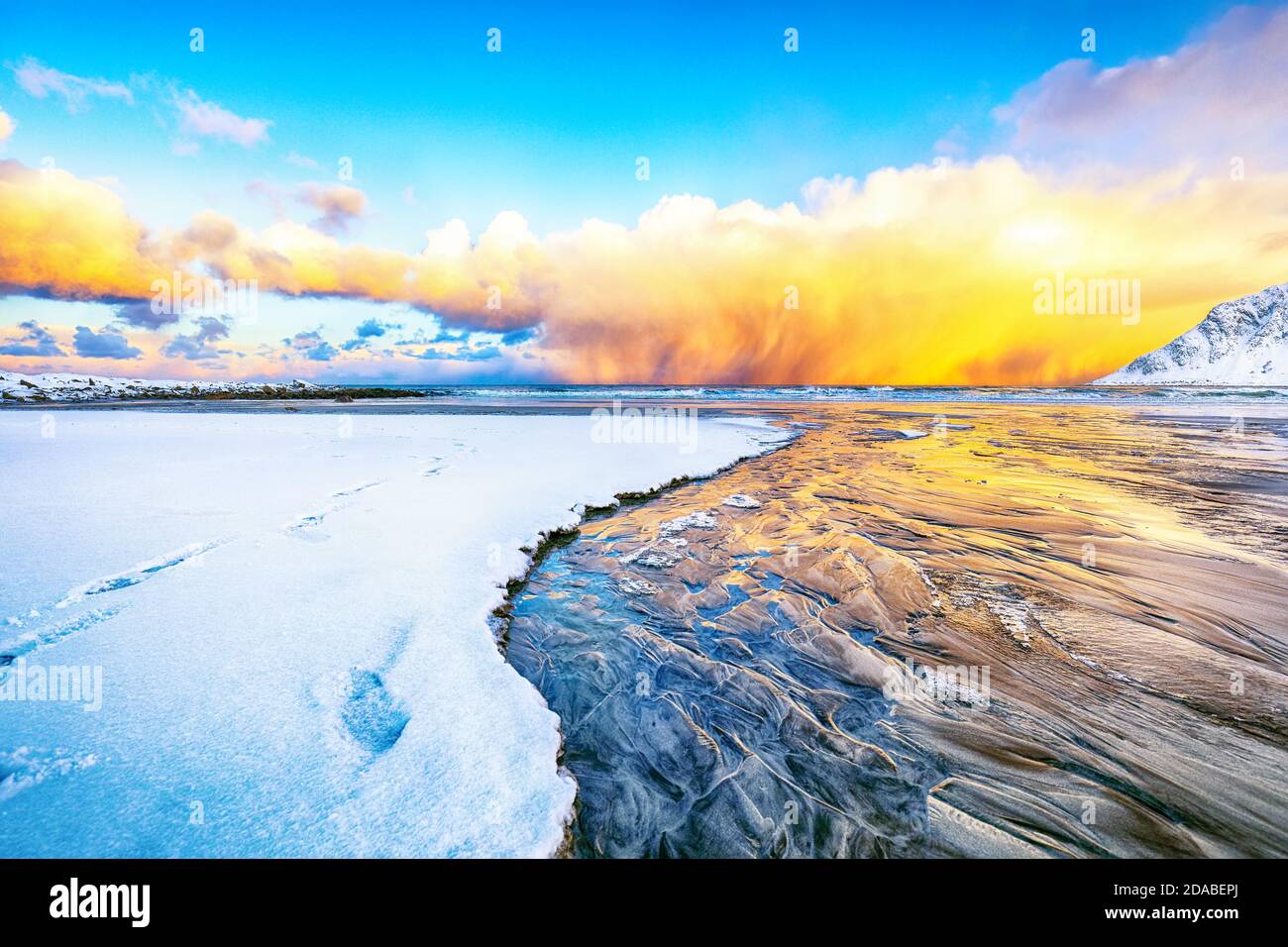 Outstanding winter scenery on Skagsanden beach with illuminated clouds during sunrise. Popular ...