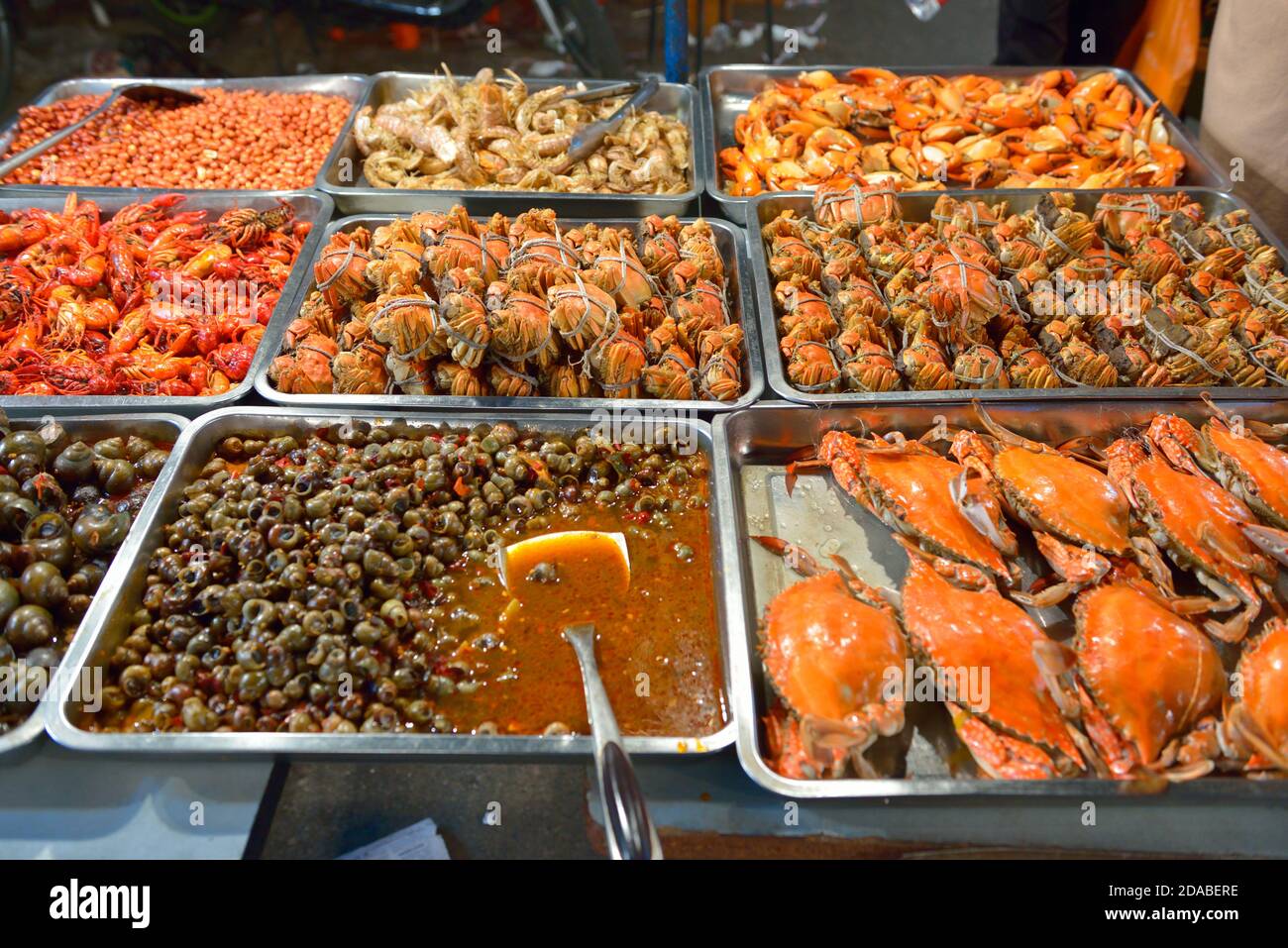 Various seafood at street market in China. Night time Stock Photo - Alamy