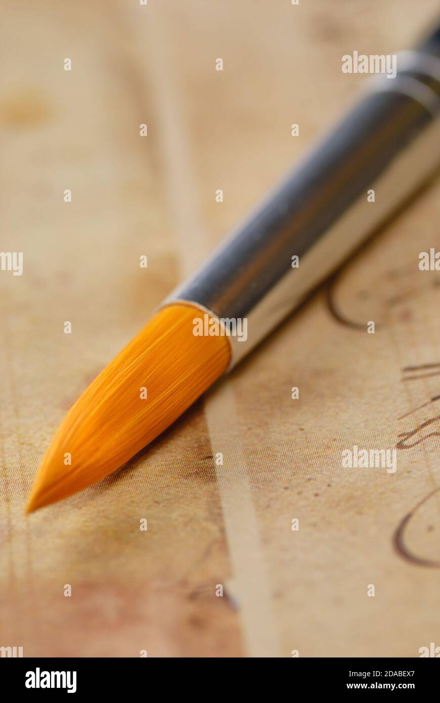 Calligraphy paint brush laying on old paper sheet Stock Photo - Alamy