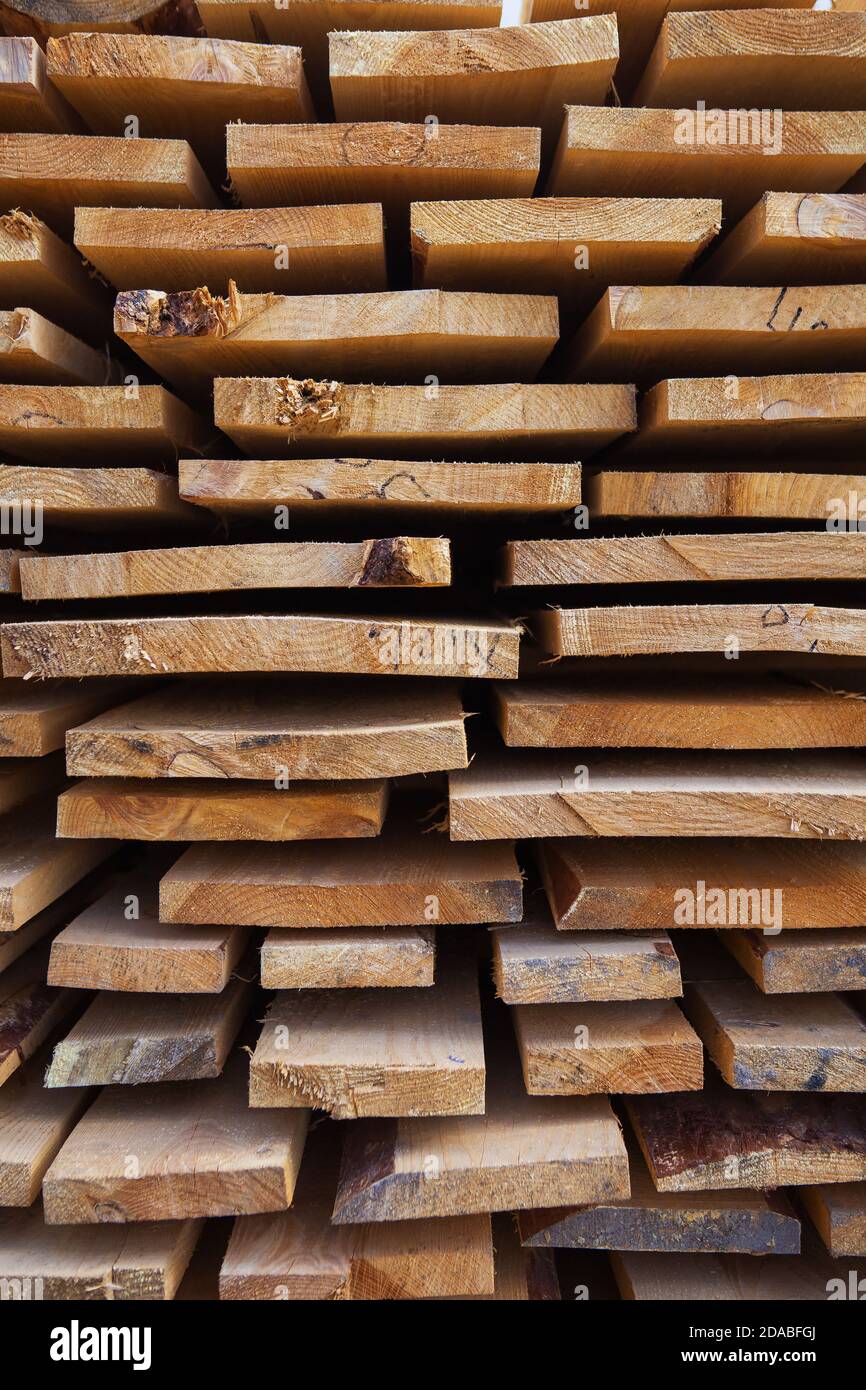 Building material in the form of fresh wooden planks at a road repair ...