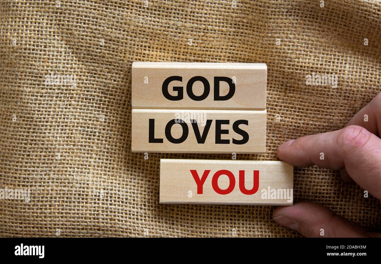 Concept words 'God loves you' on wooden blocks on a beautiful canvas ...