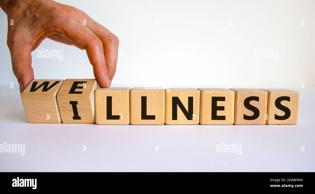 Wellness or illness. Male hand flips wooden cubes and changes the ...