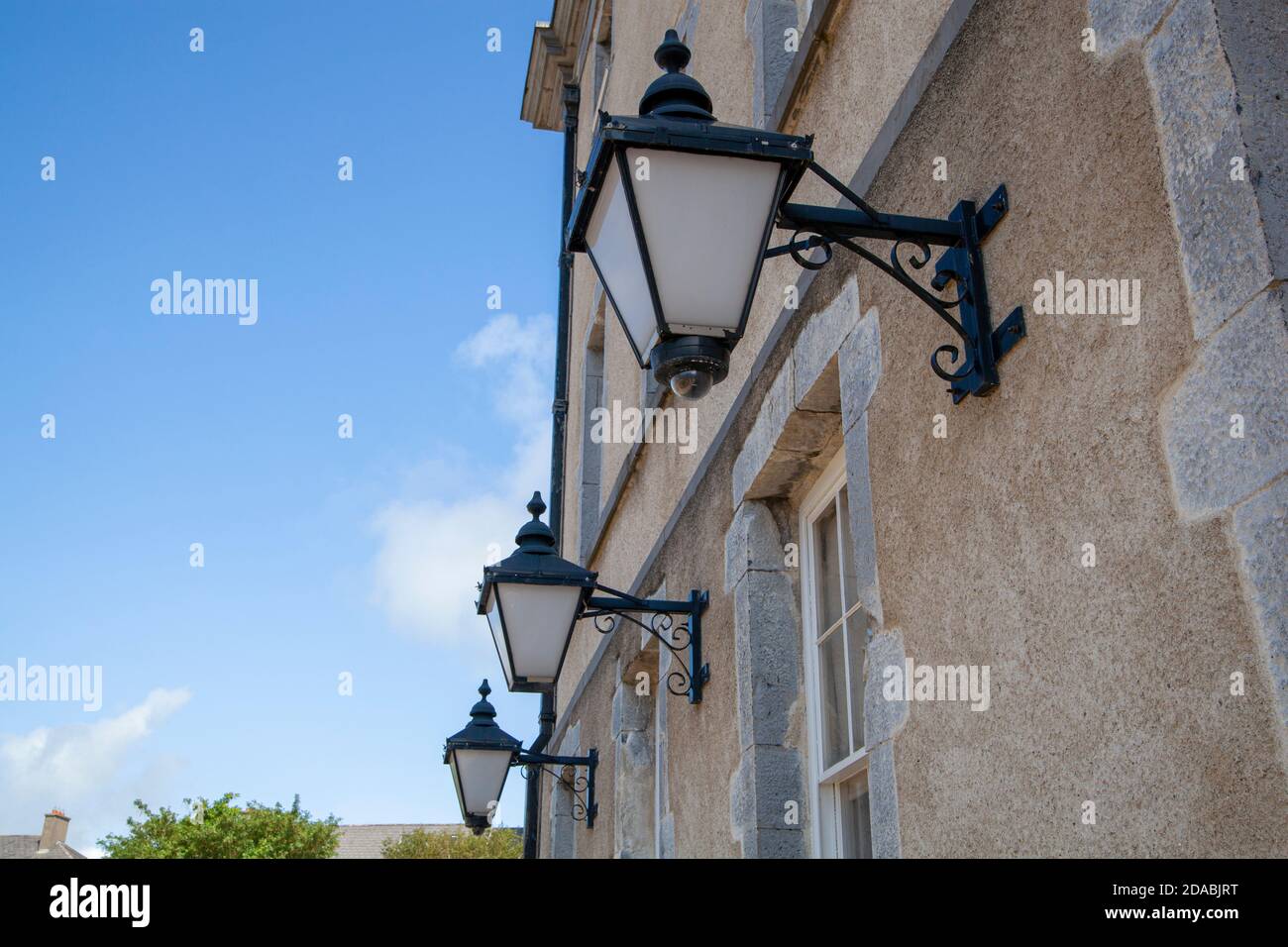 Three lanterns attached to the front of the house Stock Photo - Alamy