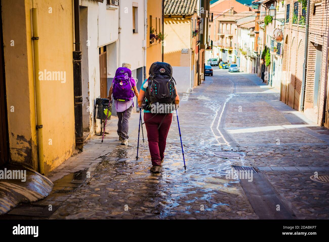 Pilgrims with backpack walking through the narrow streets of Navarrete ...