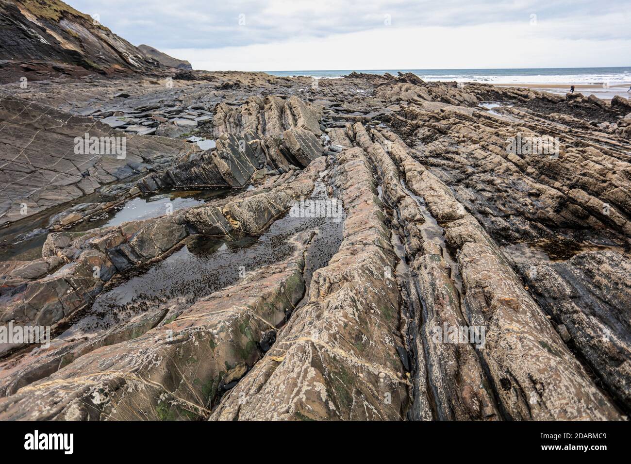 Alternating bands of sandstones and shales form the steep sides and ...