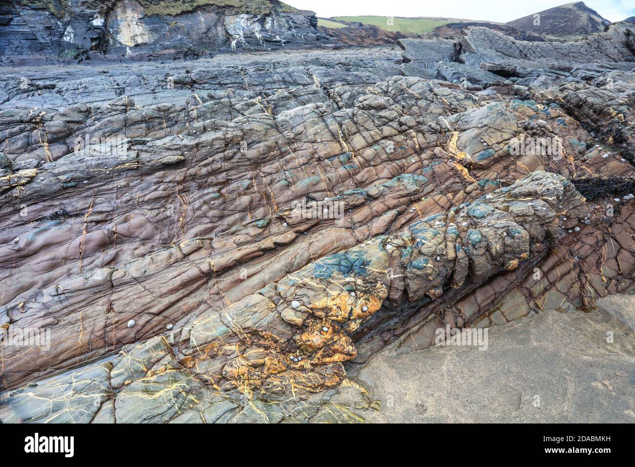 Alternating bands of sandstones and shales form the steep sides and ...