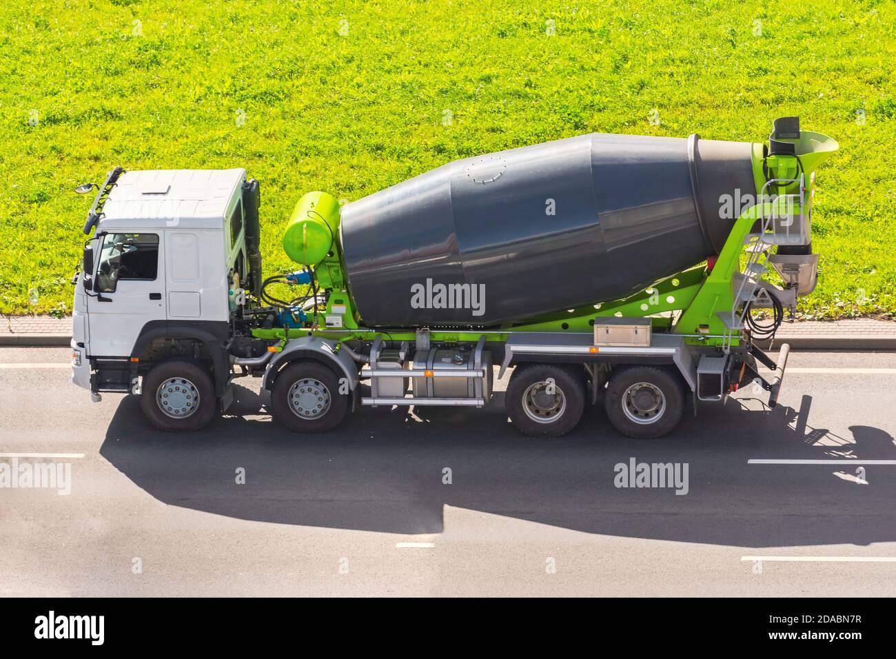 Concrete mixer new truck rides on an industrial site Stock Photo - Alamy