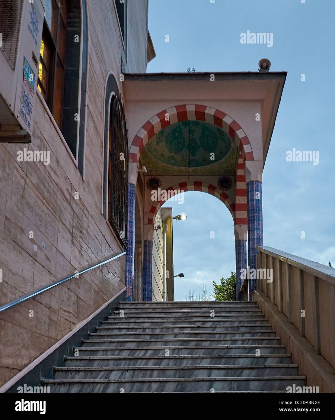 Vertical shot of stairs leading up to a decorative arched dome entrance ...
