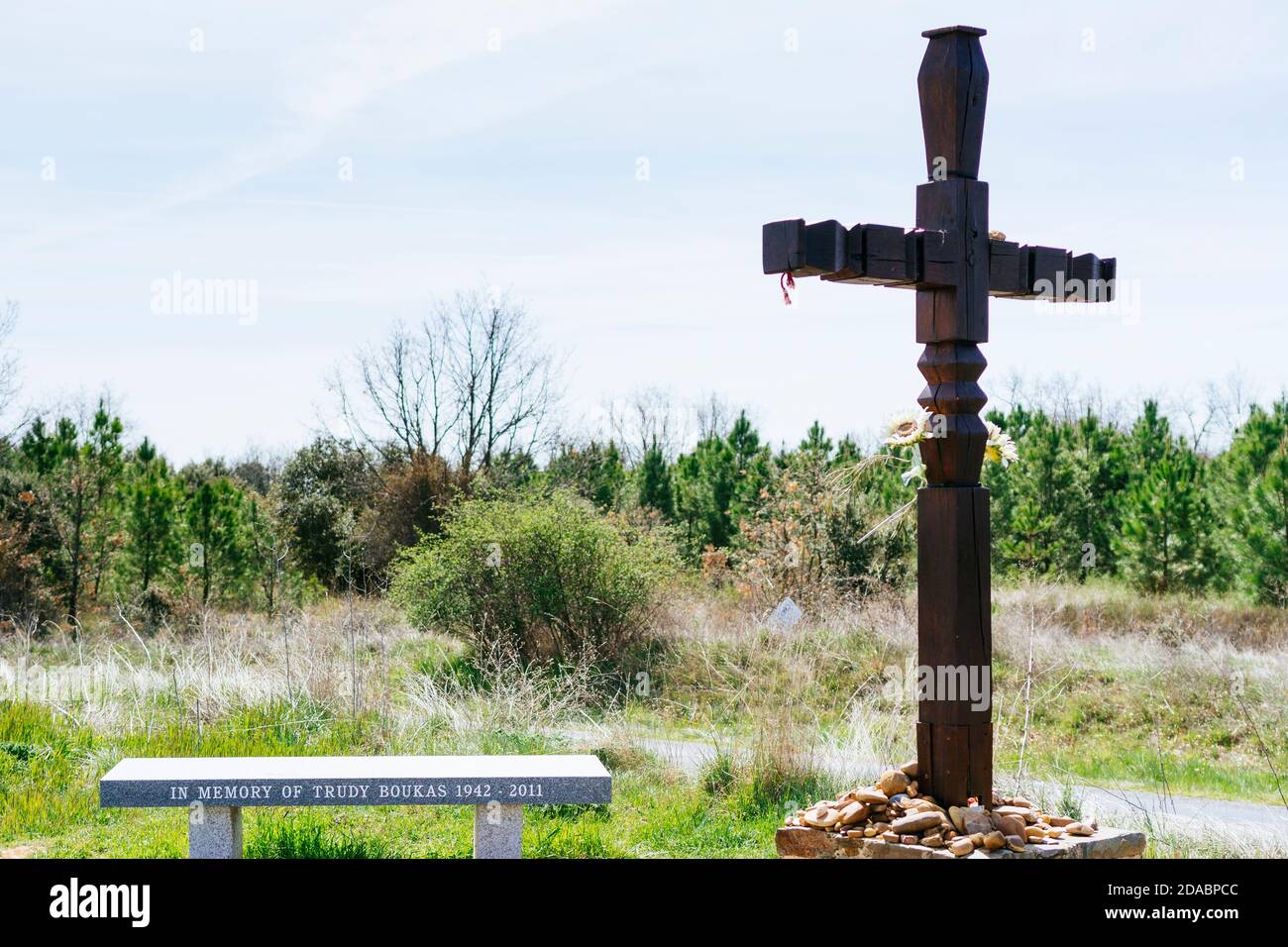 Cross in memory of the pilgrim Trudy Boukas. A bench next to the cross ...