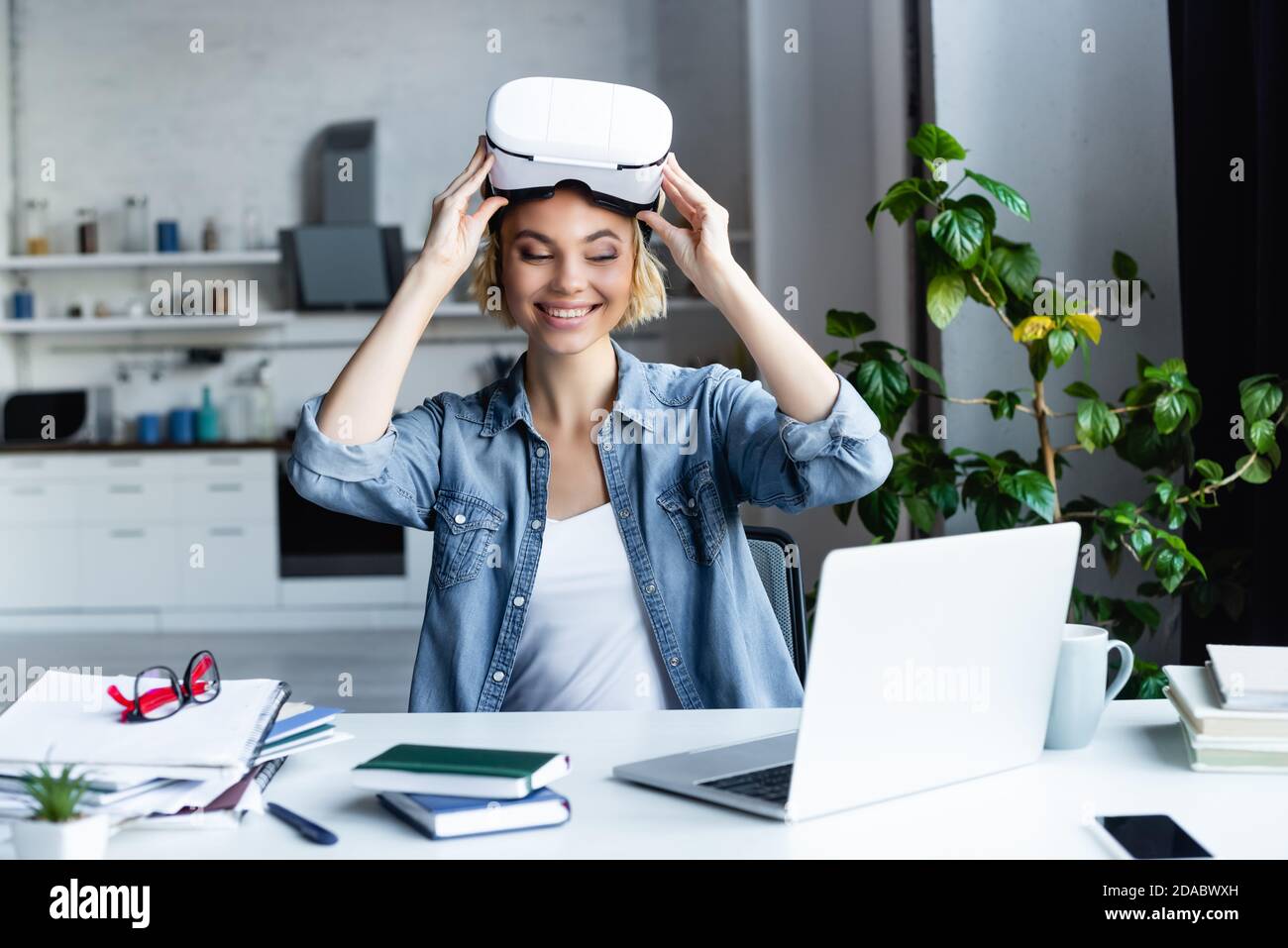Woman taking off shirt hi-res stock photography and images - Alamy
