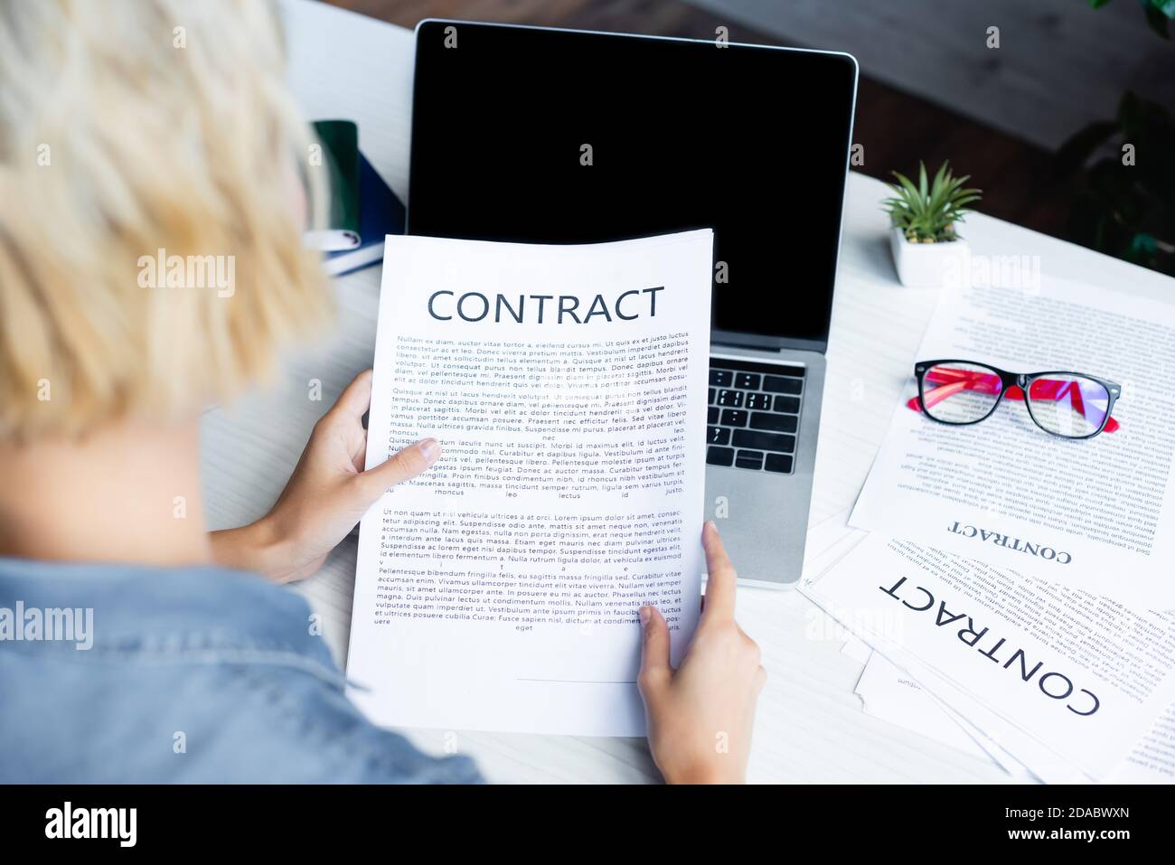 back view of woman looking at contract Stock Photo - Alamy