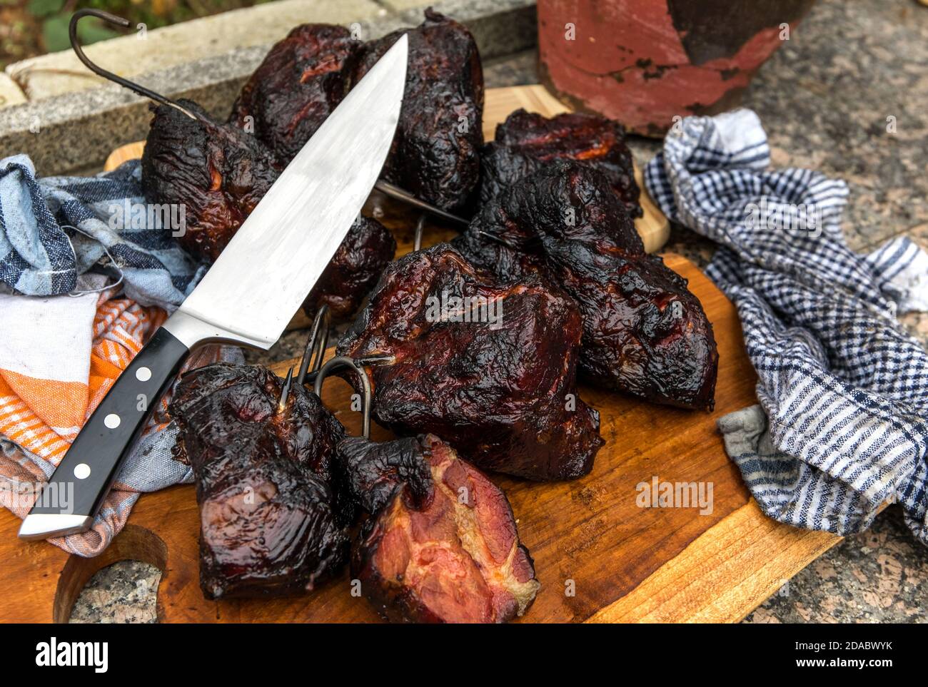 Smoking meat in the smokehouse. Traditional method of smoking meat in ...