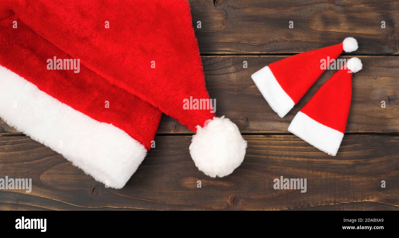 Christmas santa hats on a wooden background. Web banner idea Stock ...
