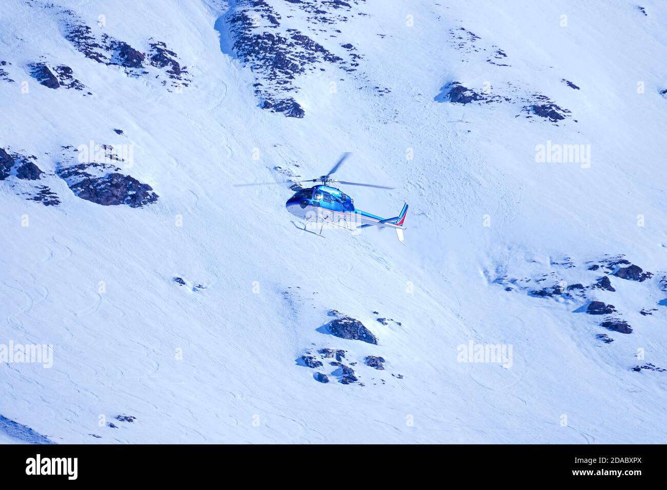 Helicopter landing on snow mountain in L'Alpes D'Huez, France. The ...