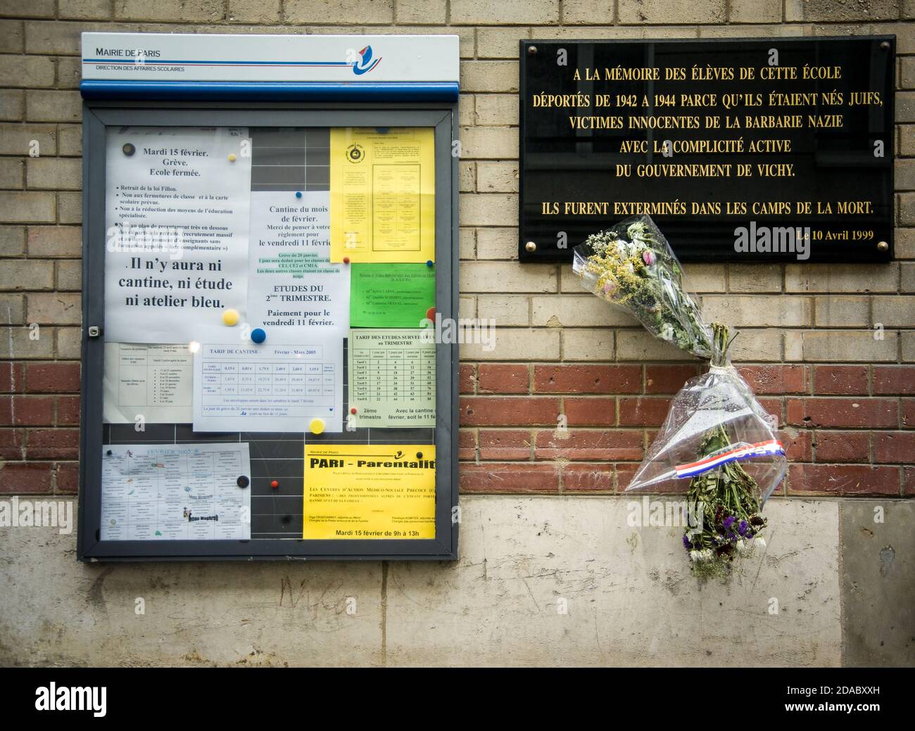 Memorial plaque and current bulletin board on a school that had all ...