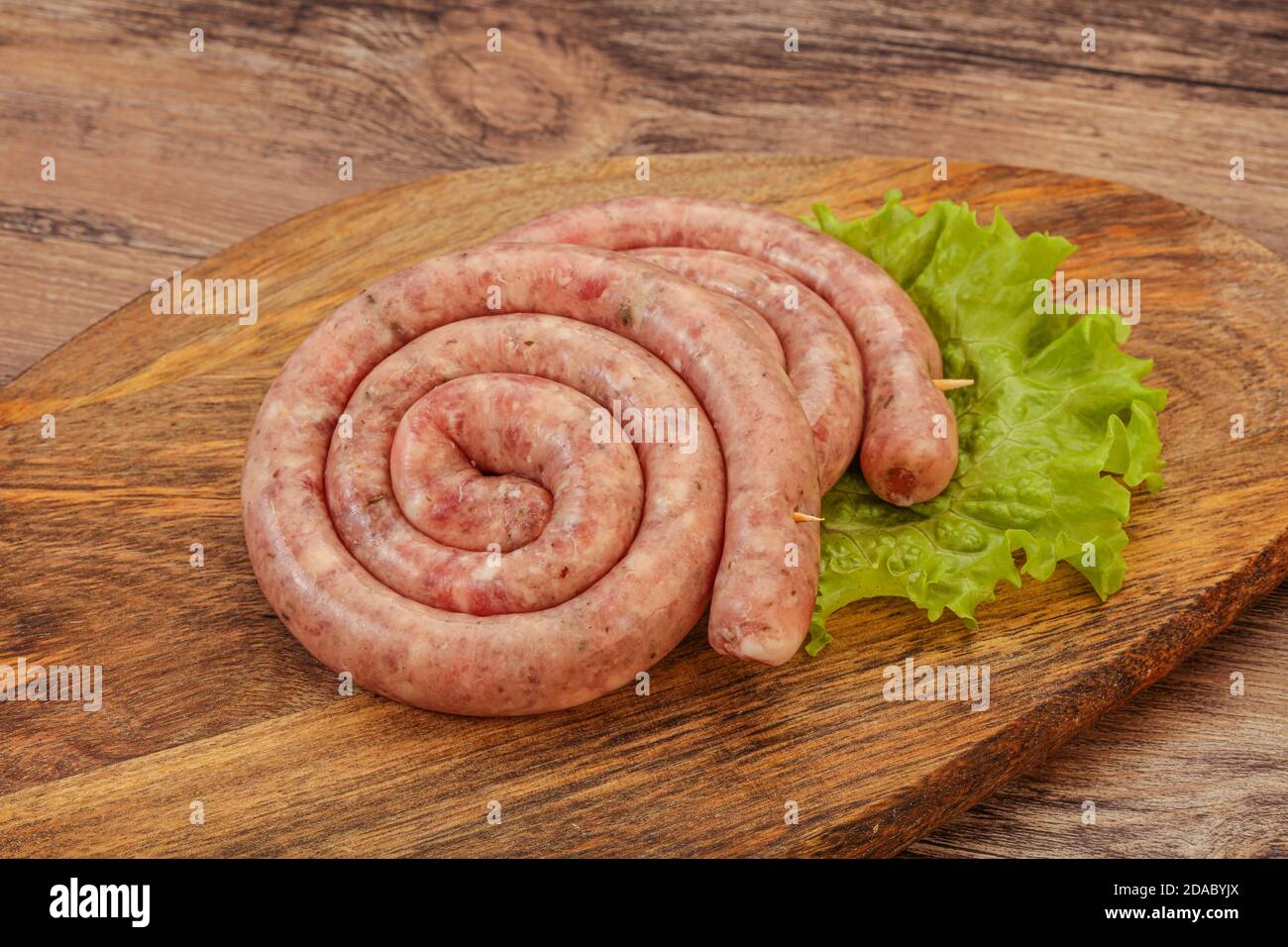 Raw pork sausage ring for grill Stock Photo - Alamy