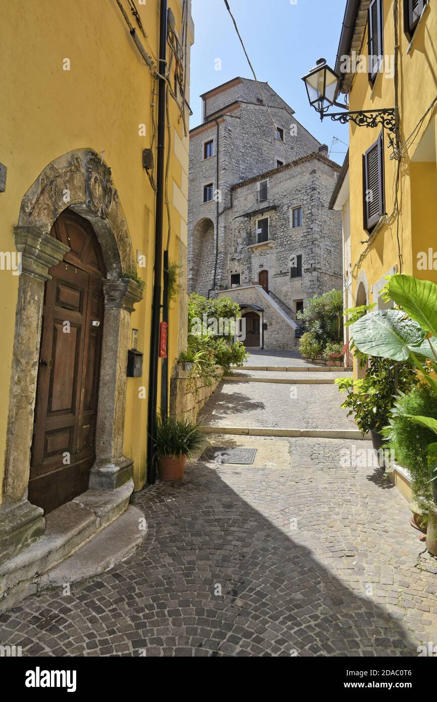 A narrow street among the old houses of Amaseno, a medieval village in ...
