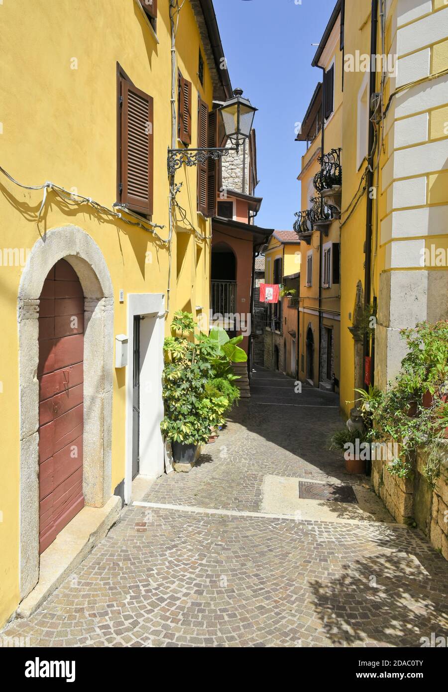 A narrow street among the old houses of Amaseno, a medieval village in ...