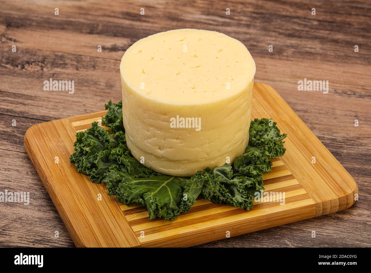 Yellow round dairy soft cheese piece Stock Photo - Alamy