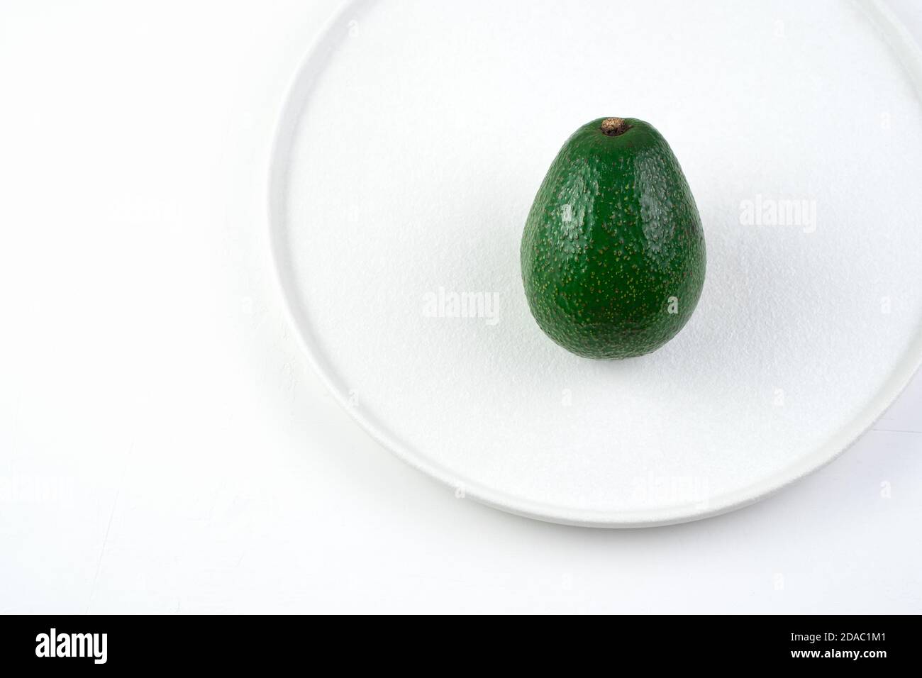 Fruit minimalistic background with avocado on a light background Stock ...