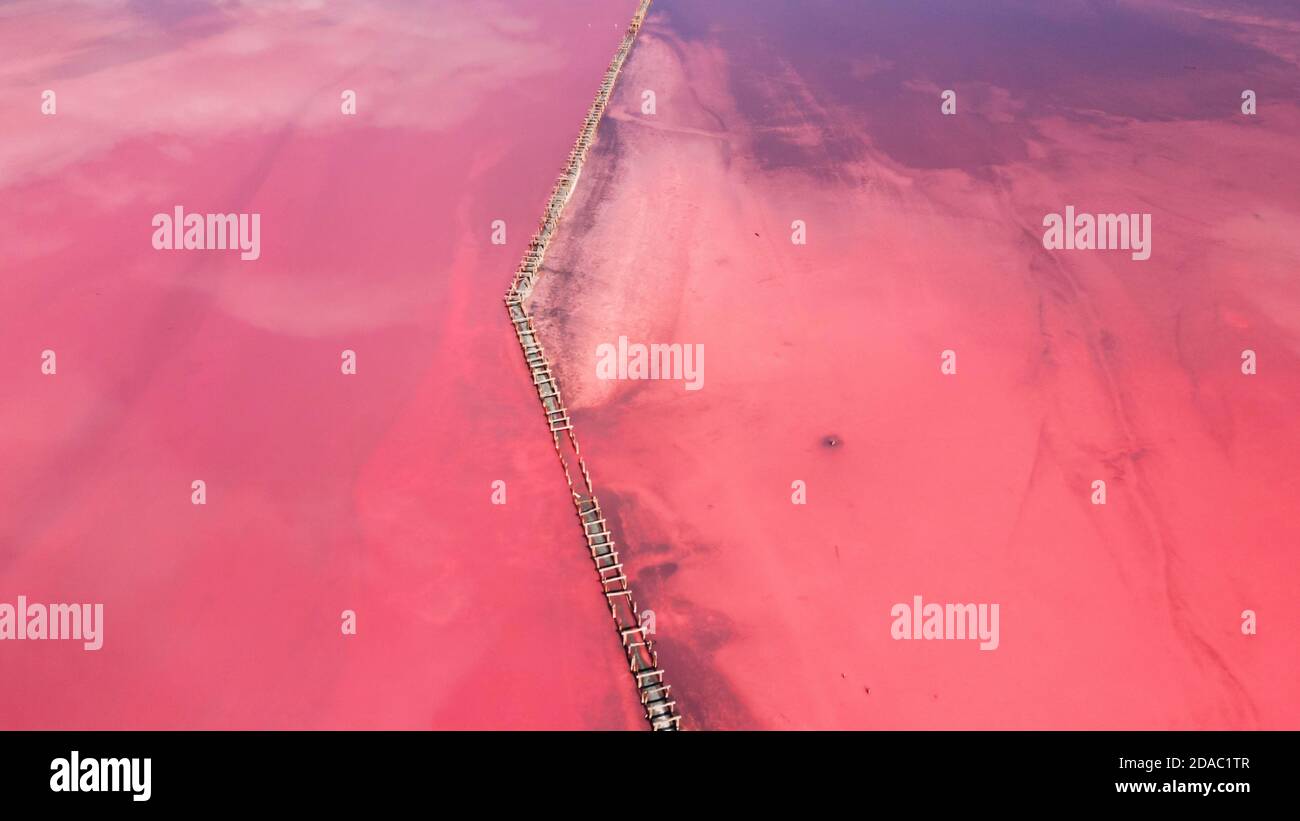 Aerial view of wooden structures for collecting salt on a pink lake ...