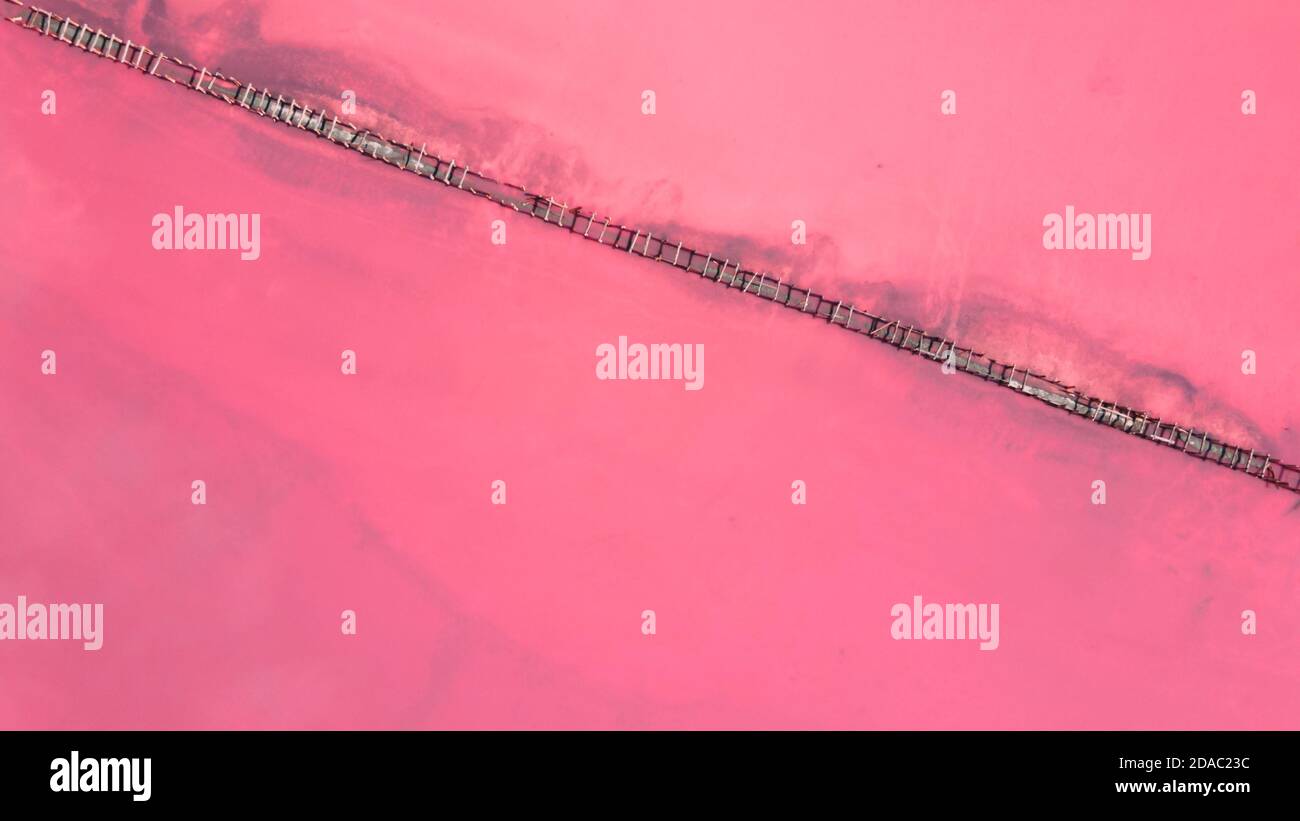 Aerial view of wooden structures for collecting salt on a pink lake ...