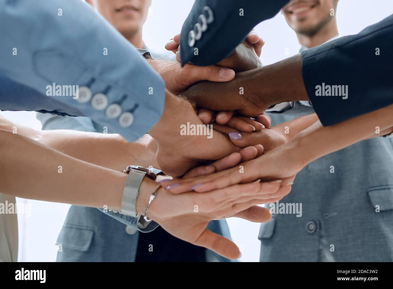 Business people joining hands in circle Stock Photo - Alamy