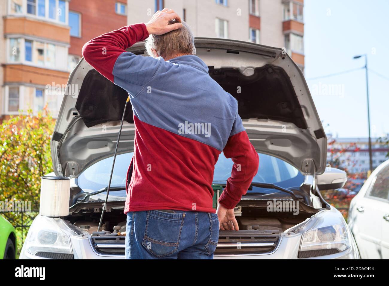 Mature driver makes a helpless gesture with hands during checking his ...