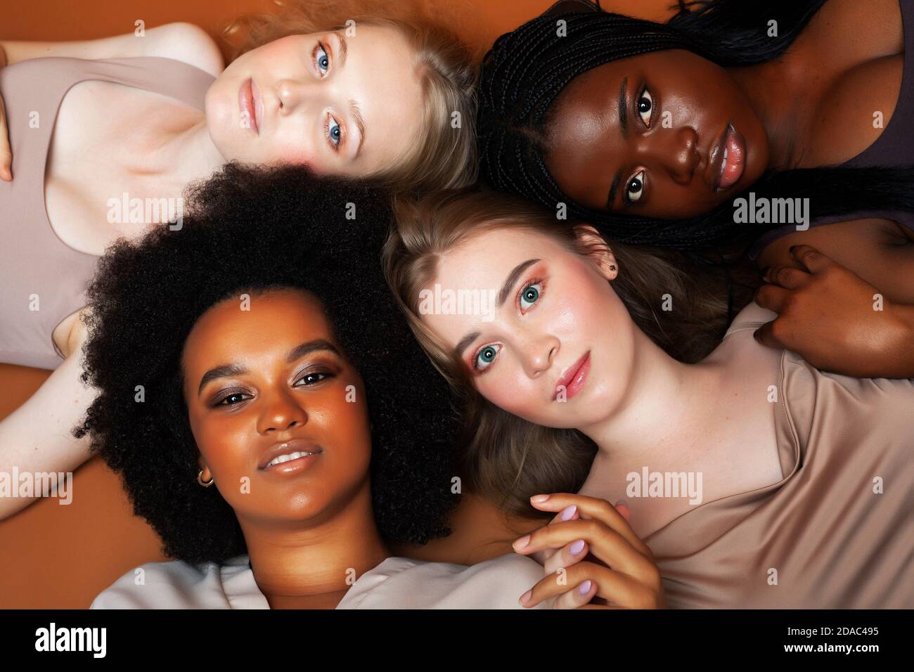 young pretty african and caucasian women posing cheerful together on ...