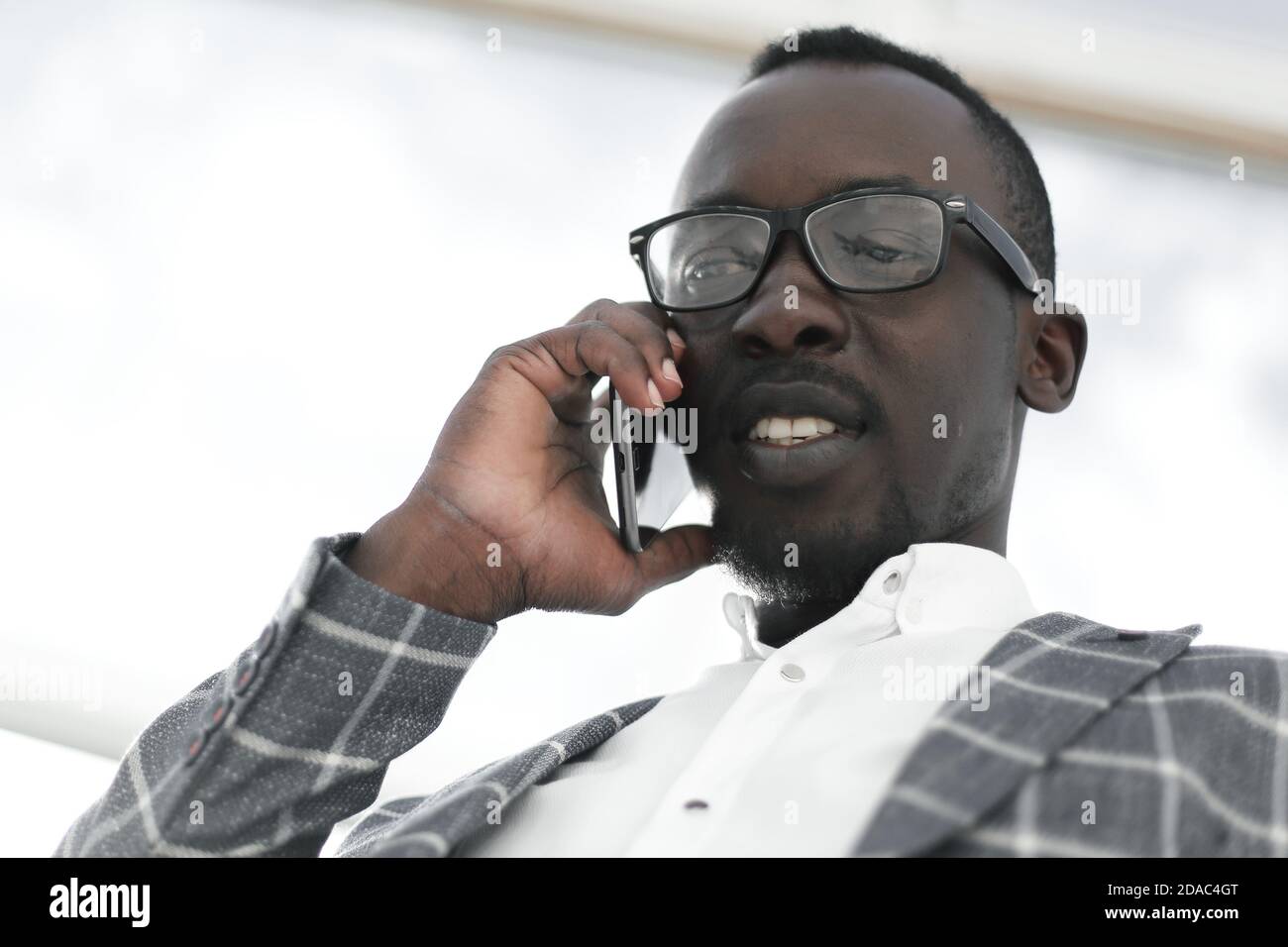 bottom view.smiling businessman talking on a mobile phone Stock Photo ...