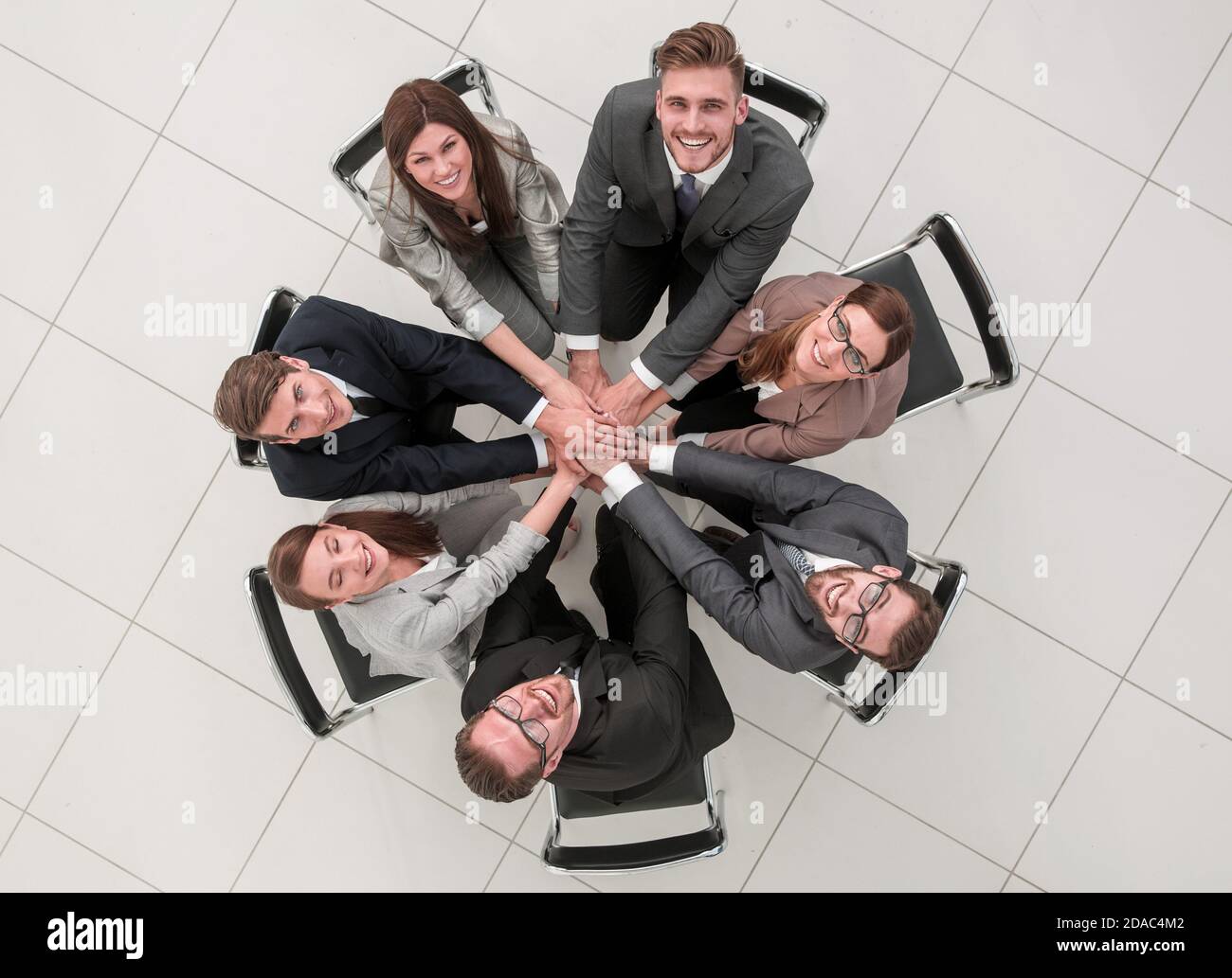 top view.smiling business team making a tower out of hands Stock Photo ...