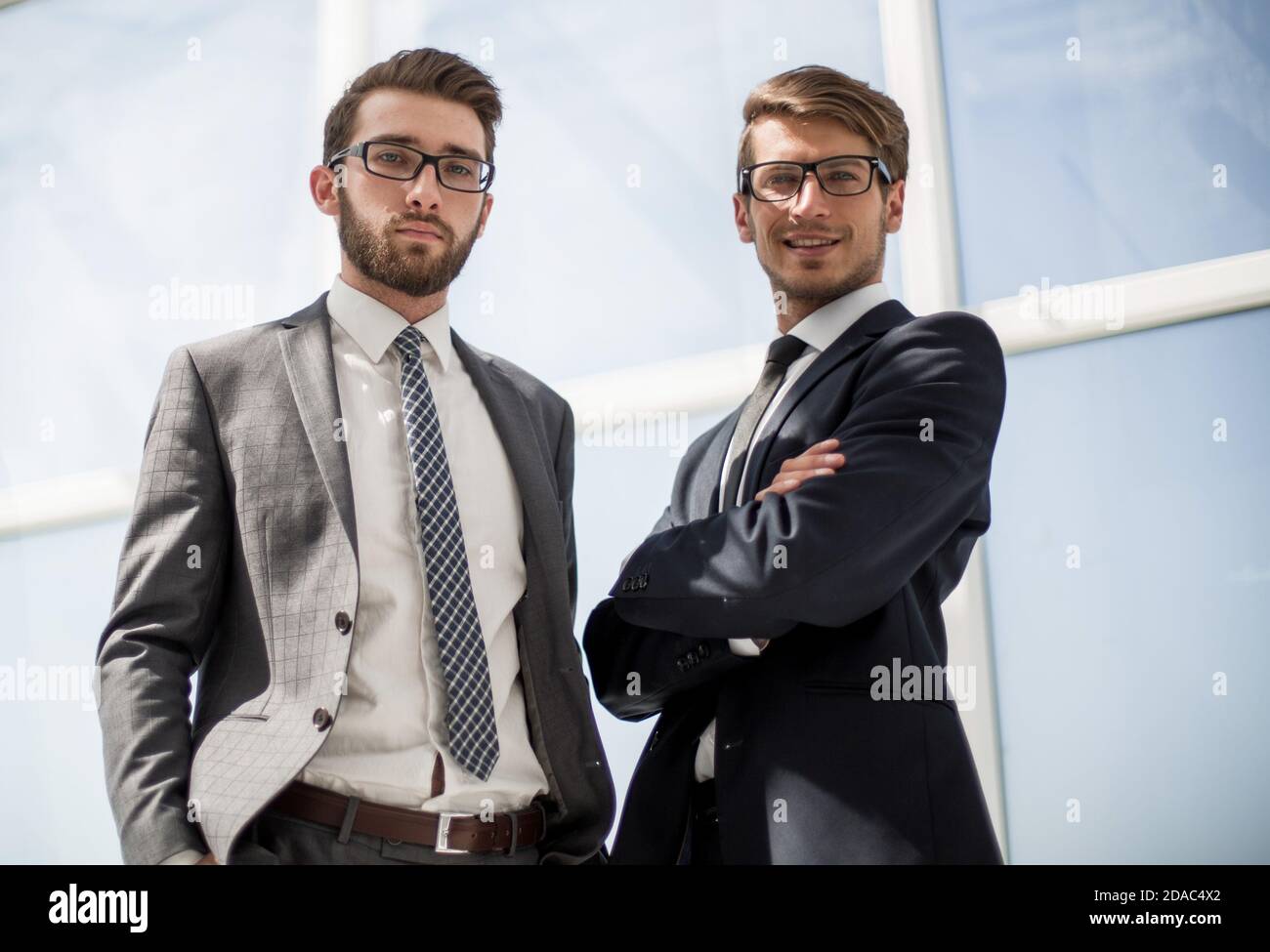 two business partners standing near the office window Stock Photo - Alamy