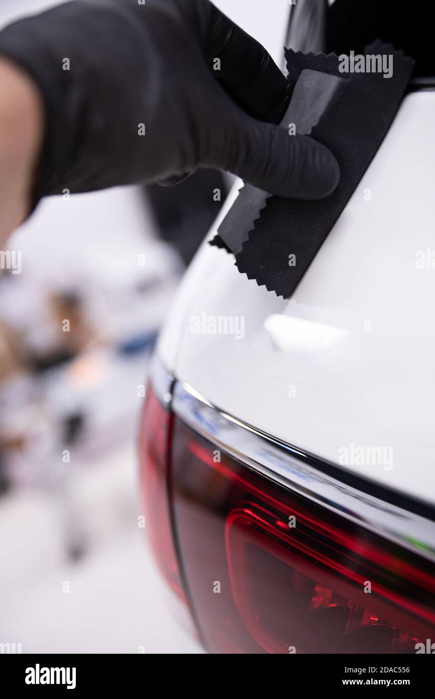 Car detailing studio worker applying car ceramic coating Stock Photo ...