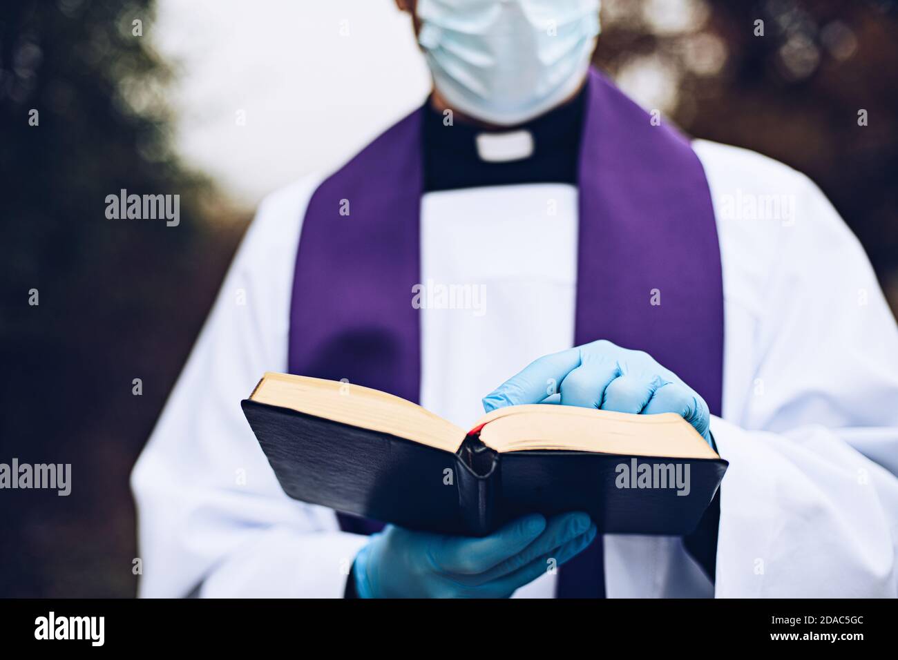 Priest with bible hi-res stock photography and images - Alamy