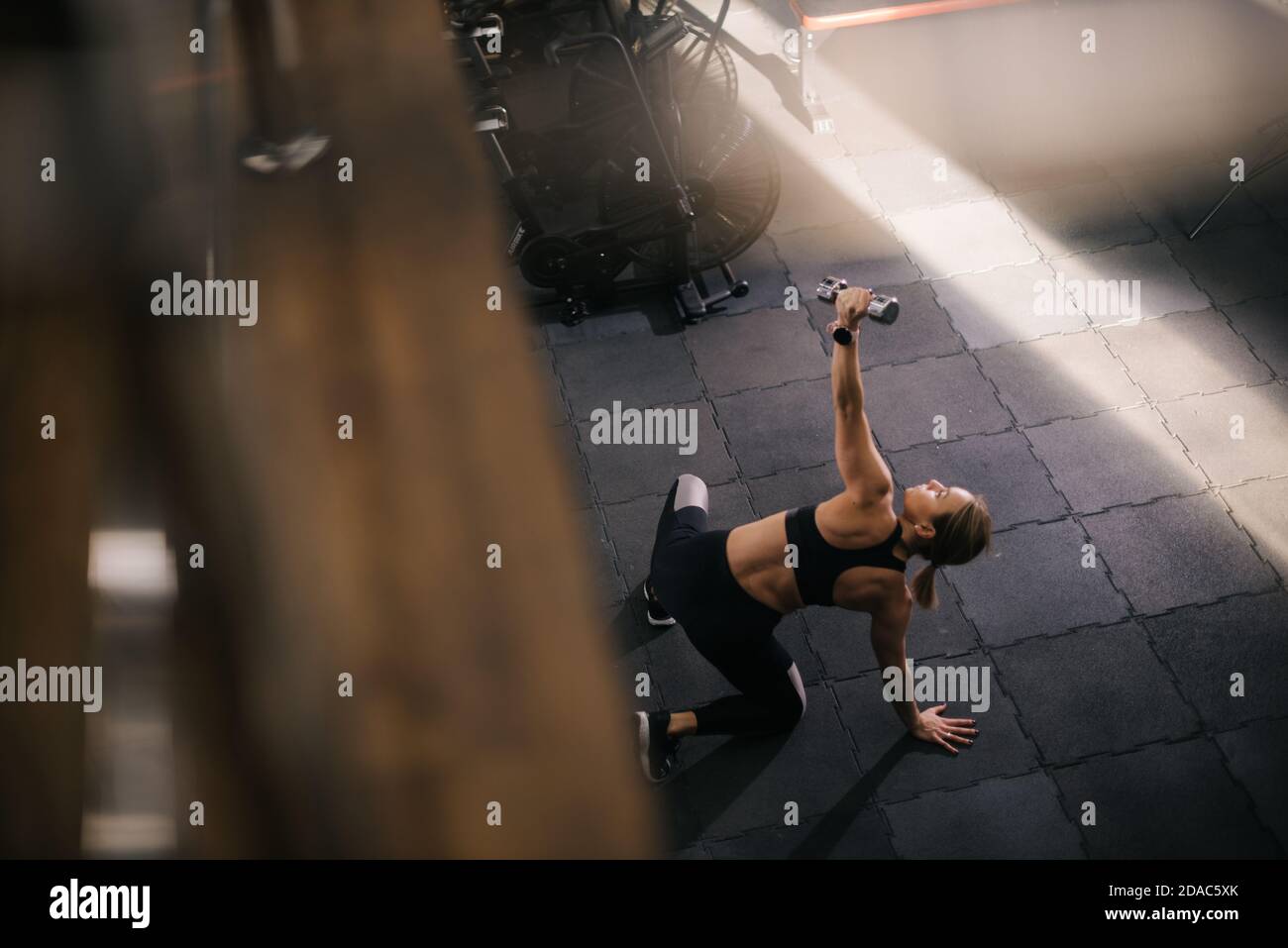 Top down view of strong young woman with athletic body lying on floor ...