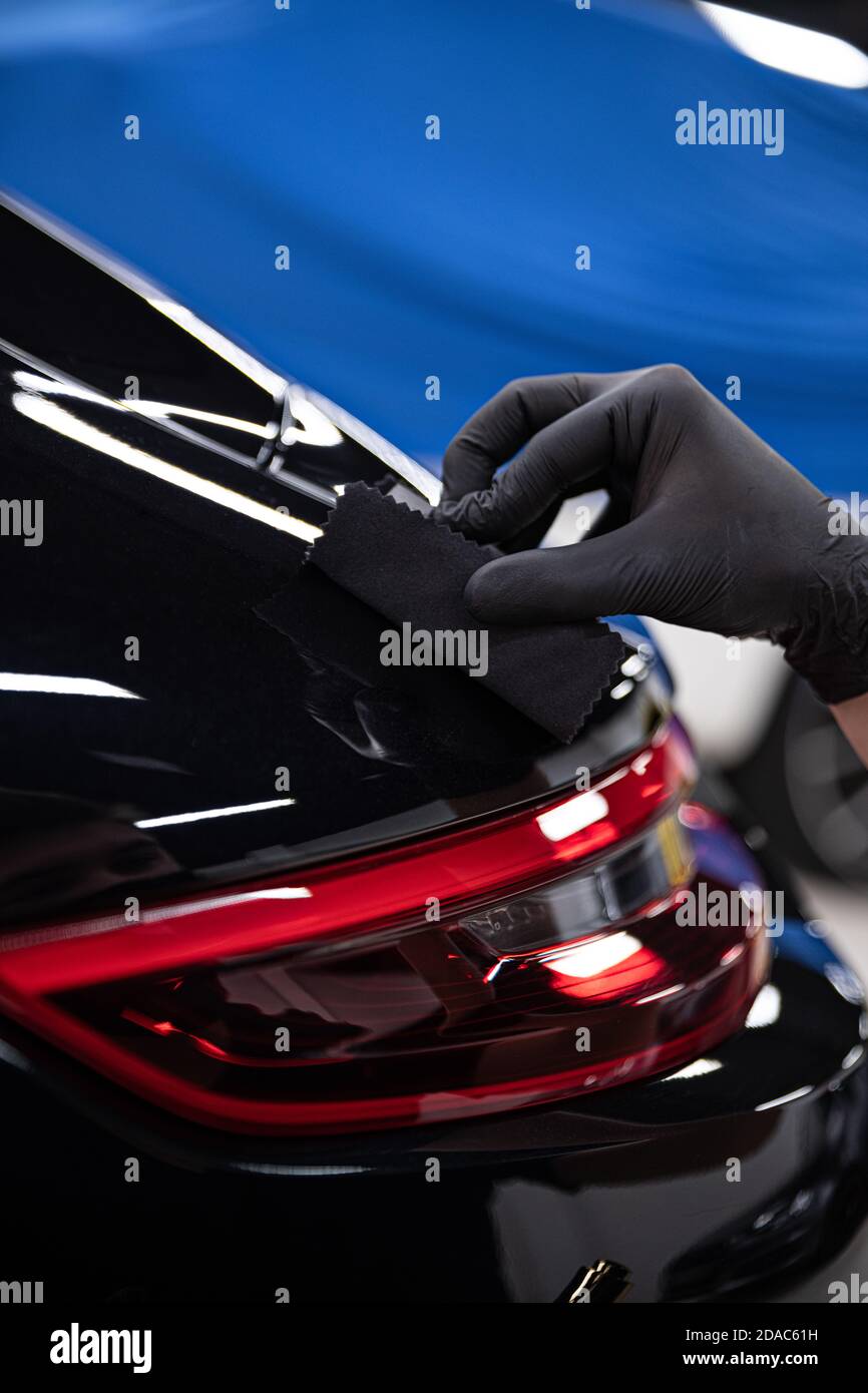 Car detailing studio worker applying car ceramic coating Stock Photo ...