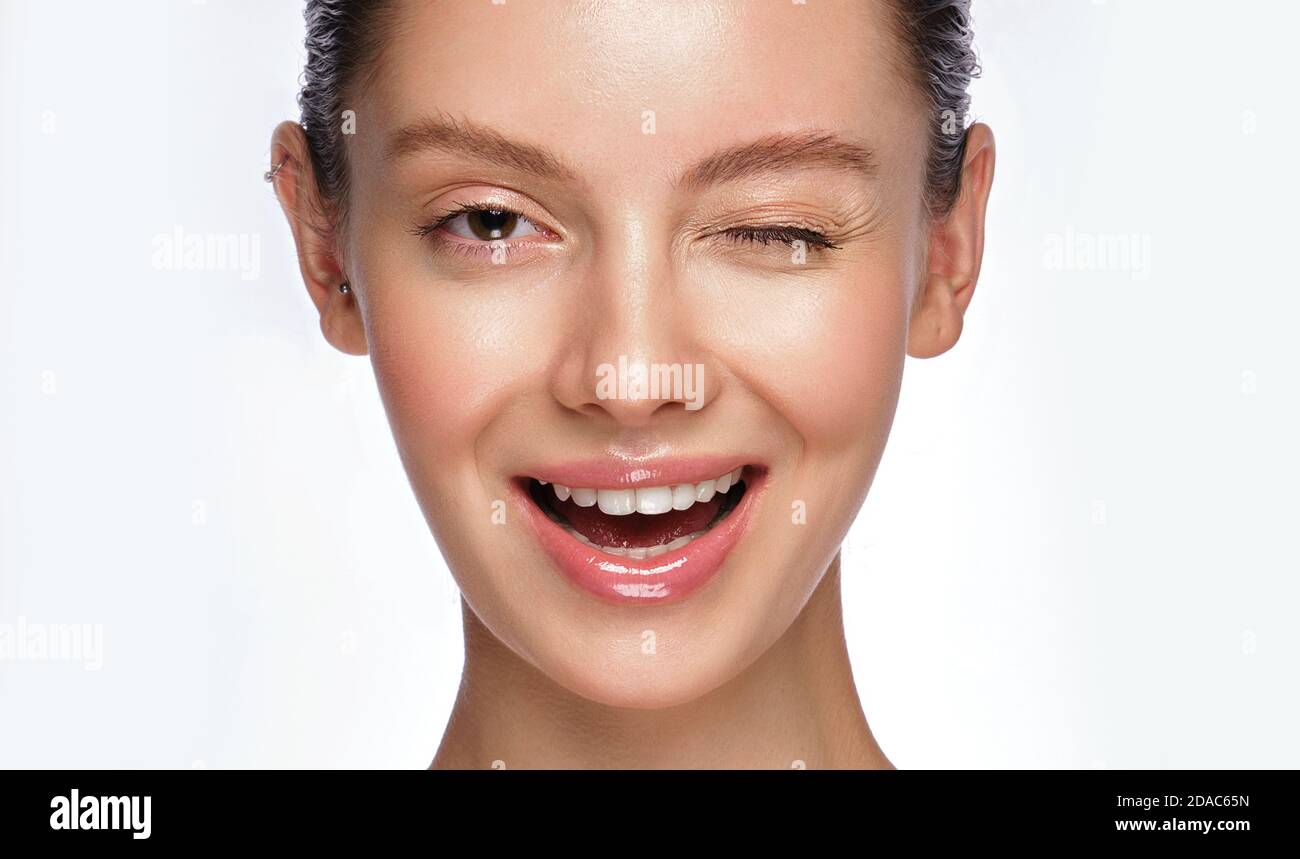 Beautiful young girl with a light natural make-up and perfect skin ...