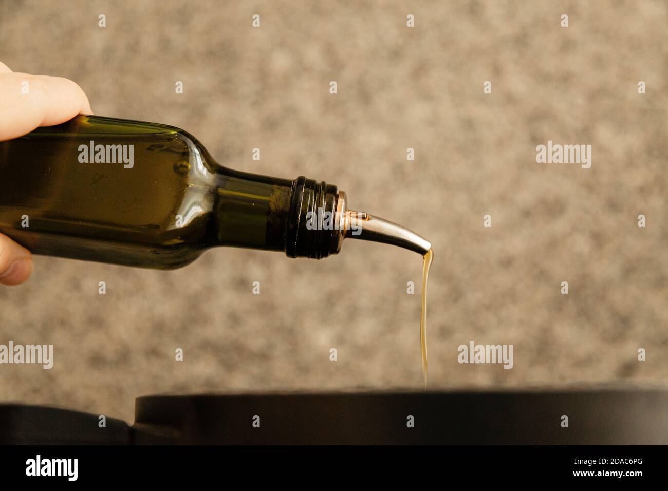 Glass jar pouring oil to prepare the food. In the kitchen Stock Photo ...