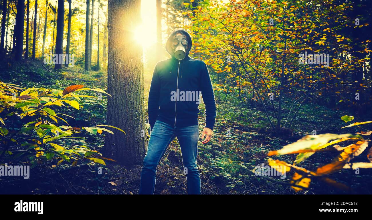 Man with gas mask in forest at sunset Stock Photo - Alamy