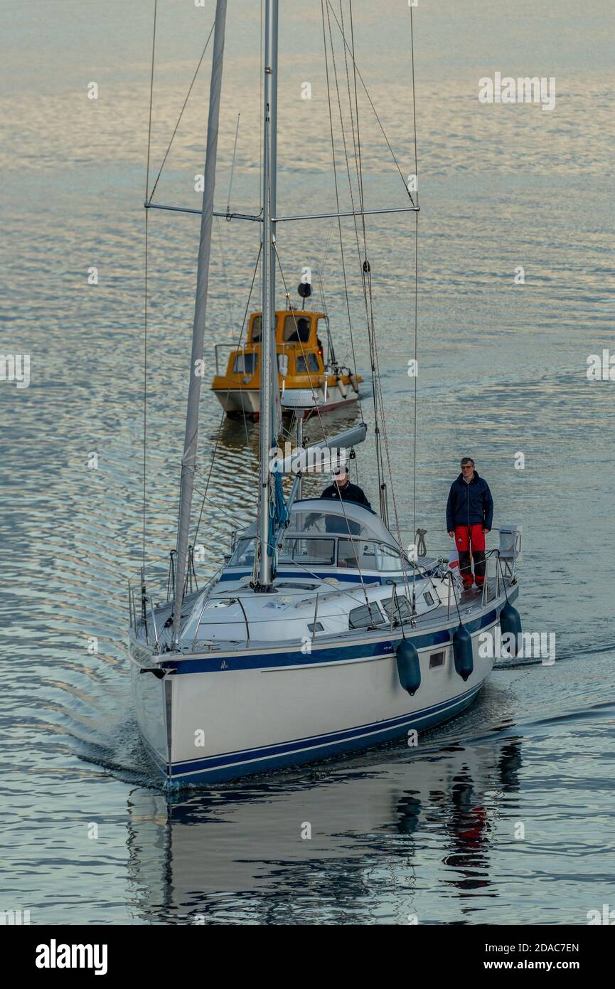 yacht entering lymington marina after a day sailing on the south coast ...