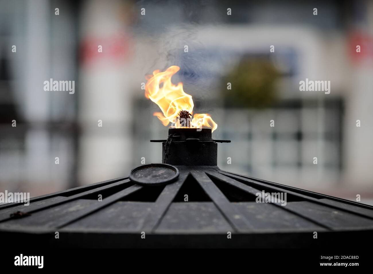 Details with an oil fueled eternal flame at a war memorial monument in ...