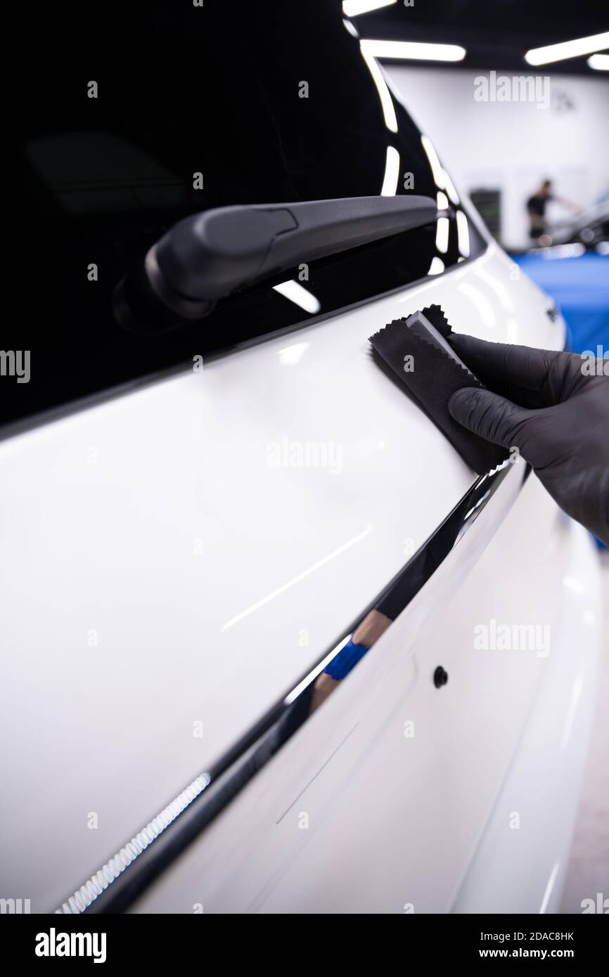 Car detailing studio worker applying car ceramic coating Stock Photo ...